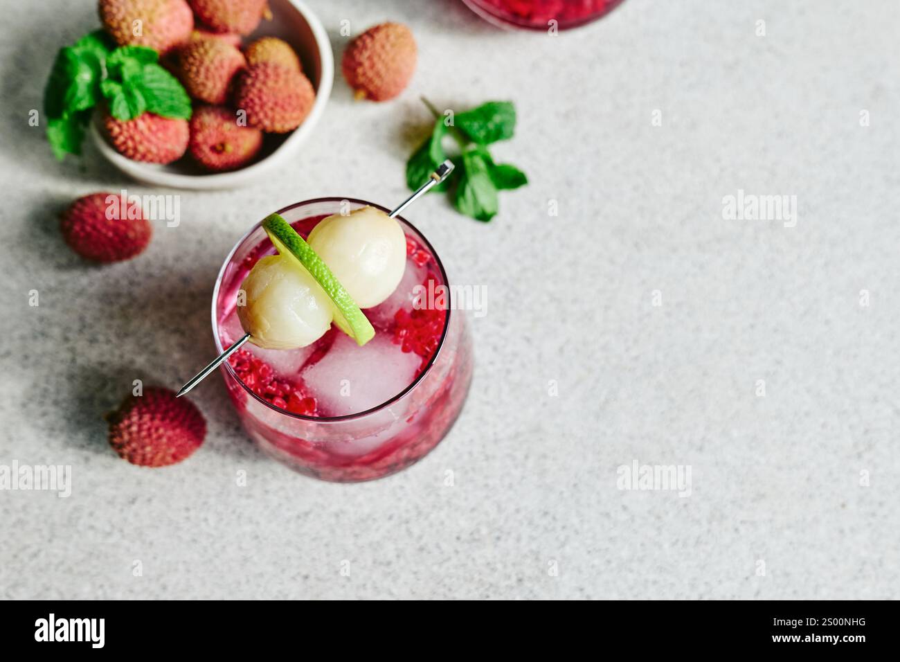 Refreshing lychee drink with raspberry, lime, mint leaves and ice. Non-alcoholic sparkling ...