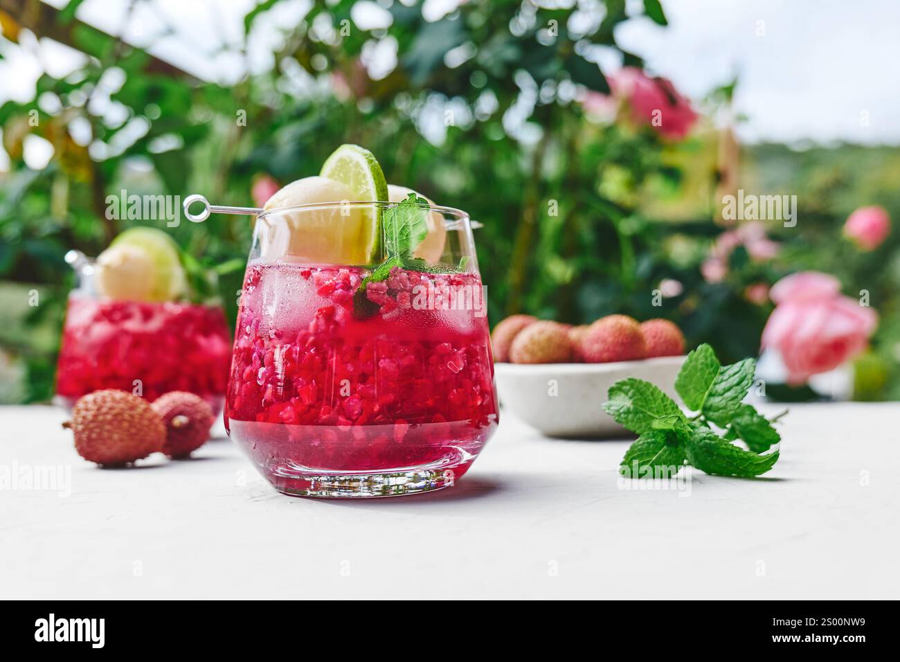 Refreshing lychee drink with raspberry, lime, mint leaves and ice. Non-alcoholic sparkling ...