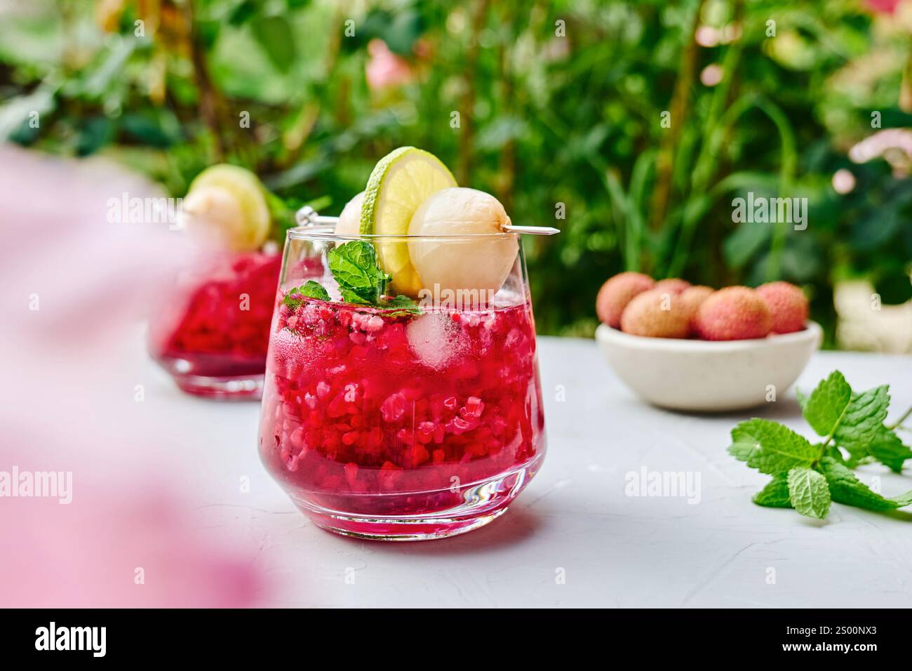 Refreshing lychee drink with raspberry, lime, mint leaves and ice. Non-alcoholic sparkling ...