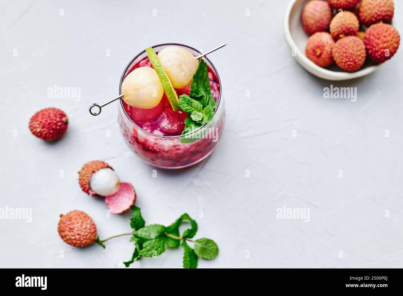 Refreshing lychee drink with raspberry, lime, mint leaves and ice. Non-alcoholic sparkling ...