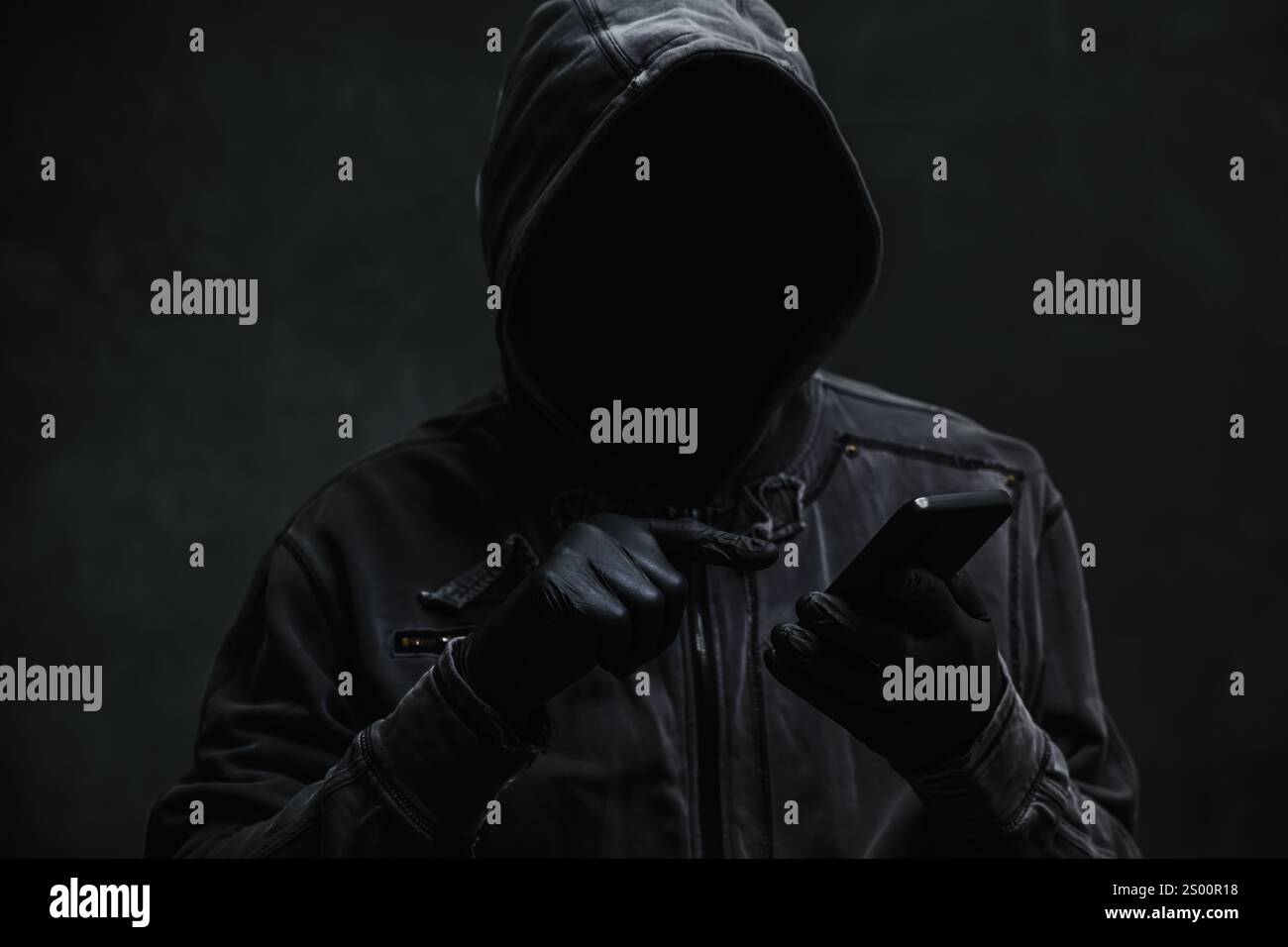 Hooded computer hacker using smartphone, selective focus Stock Photo ... Hooded computer hacker using smartphone, selective focus Stock Photo ...