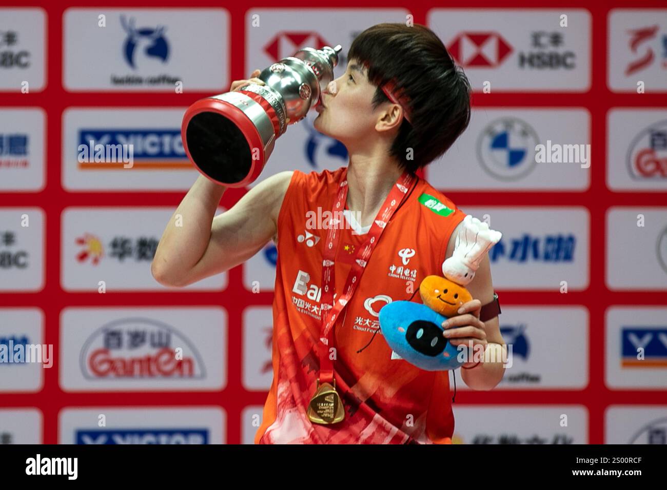 Wang Zhi Yi of China kisses the winning trophy after defeating her compatriot Han Yue in the ...