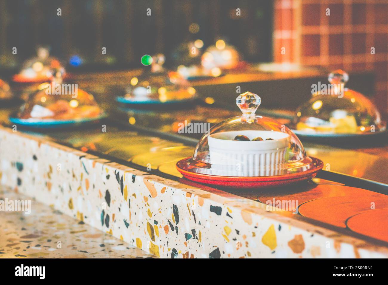 italian tapas served on small plates and put on a coveyor belt in a ...