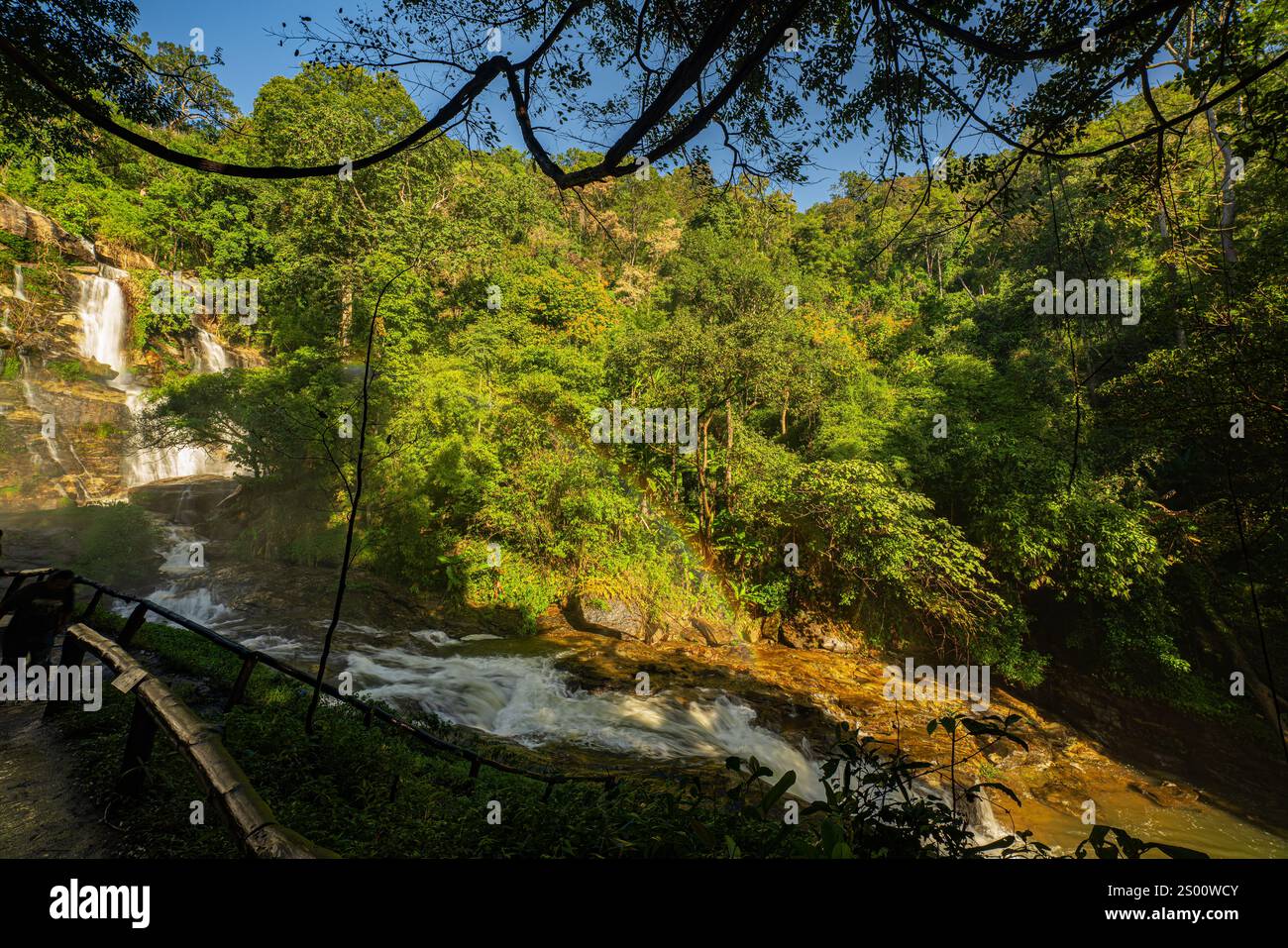 Wachirathan waterfall Chiang Mai is surrounded by lush greenery, with a ...