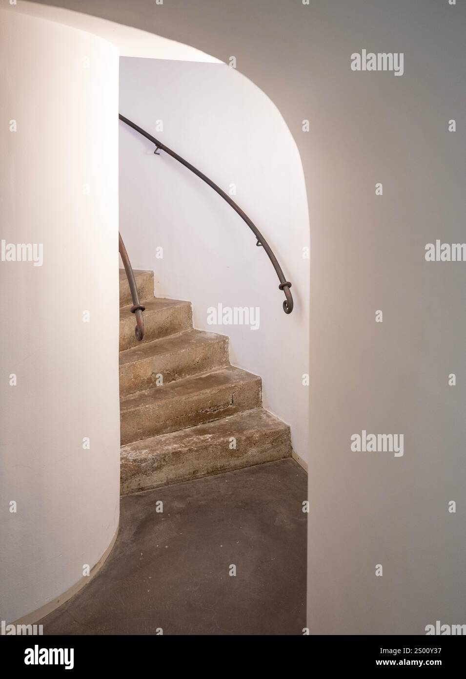 bottom steps of winding concrete staircase in old building Stock Photo ...