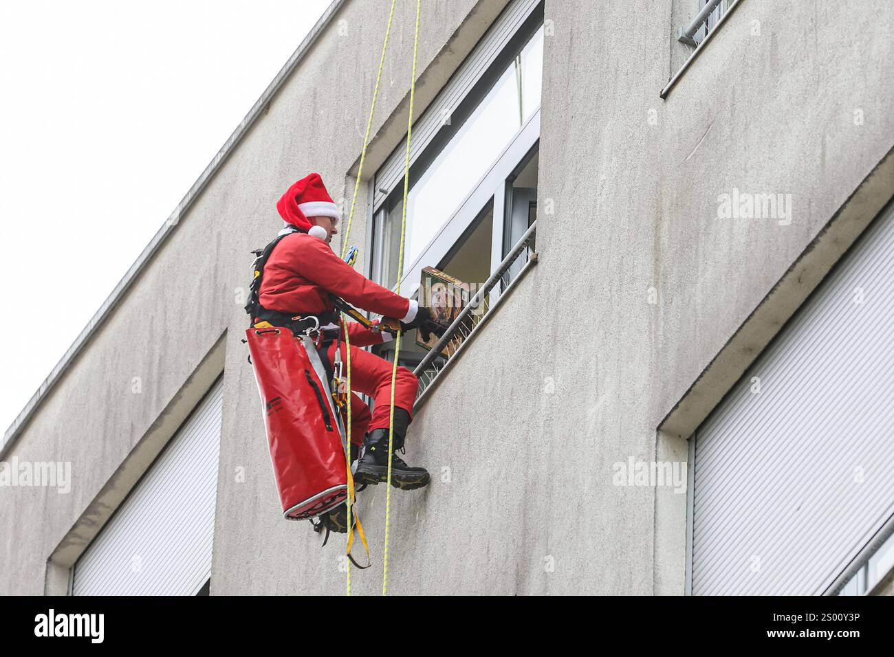 Zagreb, Zagreb. 23rd Dec, 2024. People dressed as Santa Claus rappel ...