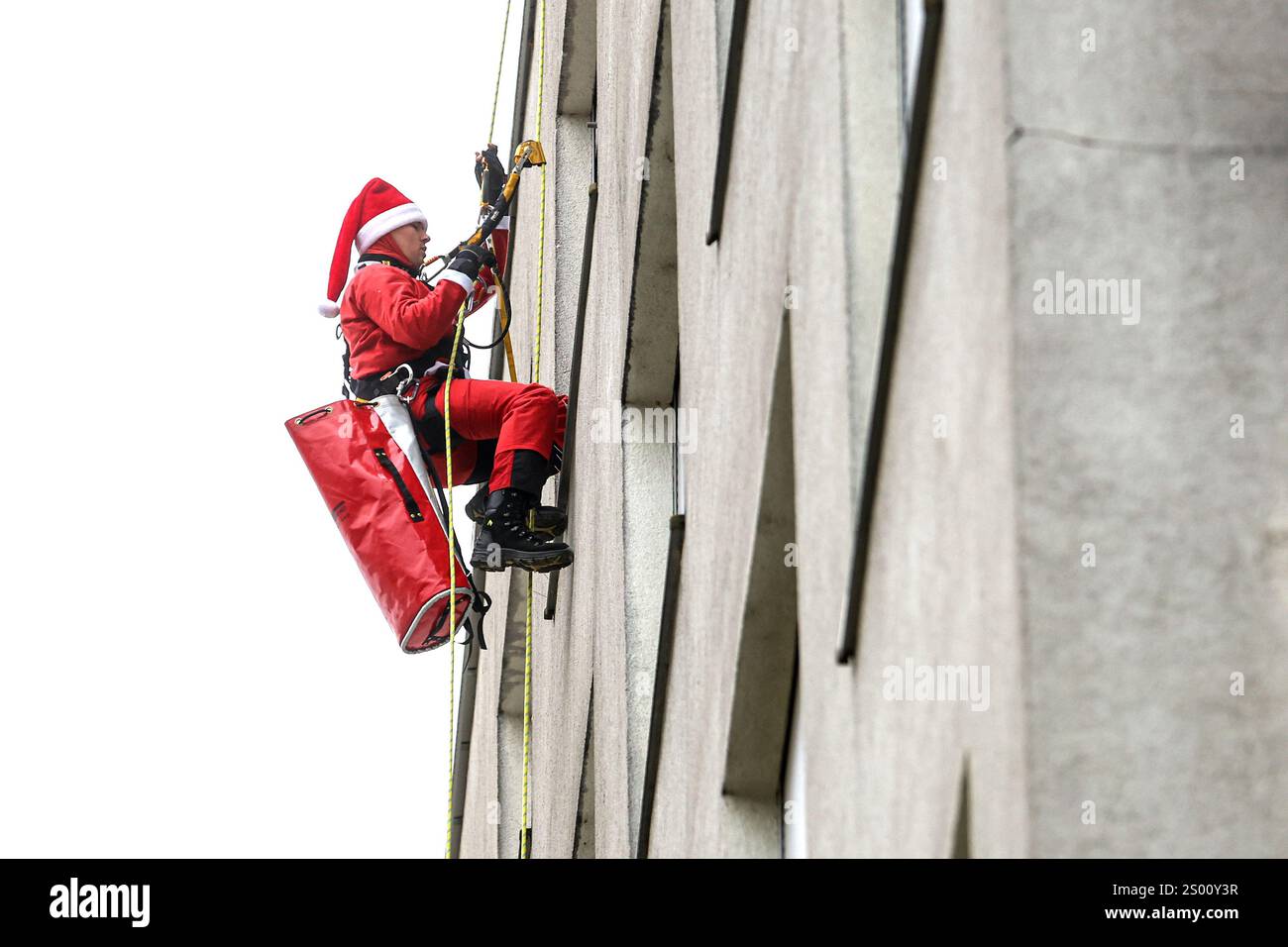 Zagreb, Zagreb. 23rd Dec, 2024. People dressed as Santa Claus rappel ...
