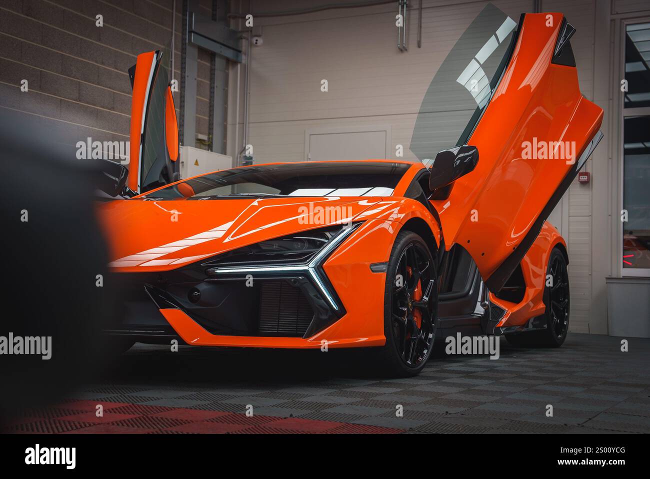 Orange Lamborghini Revuelto with Scissor Doors Open Indoors Stock Photo ...