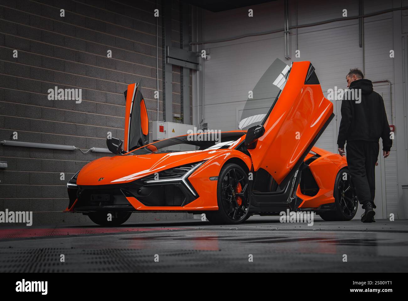 Orange Lamborghini Revuelto with Scissor Doors in Industrial Garage ...