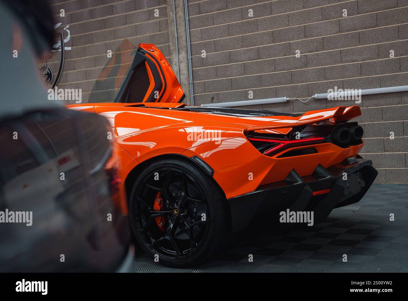 Vibrant Orange Lamborghini Revuelto with Open Scissor Door Indoors ...