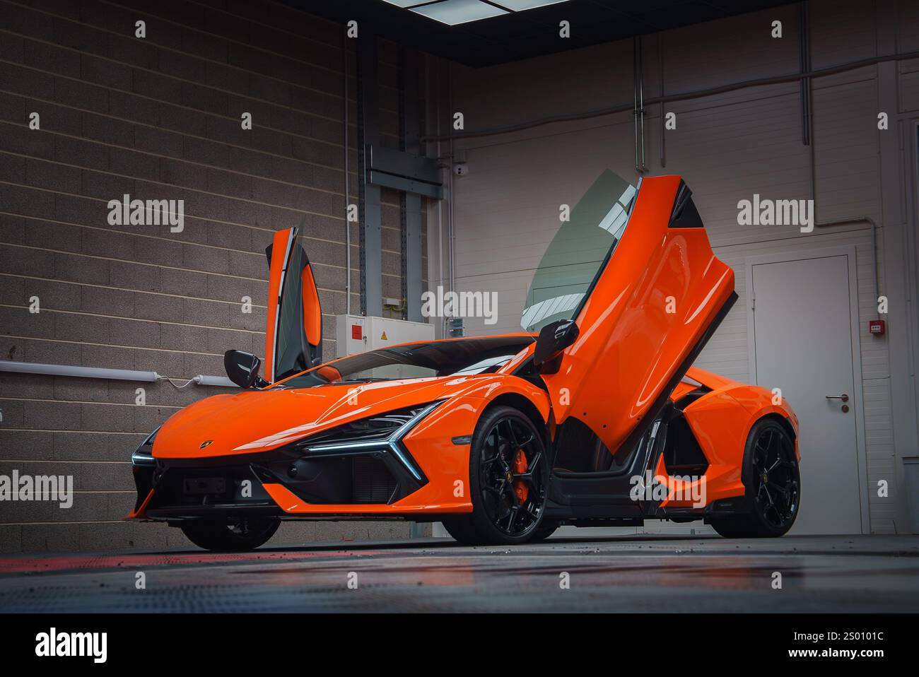 Orange Lamborghini Revuelto with Scissor Doors Open in Showroom Stock ...