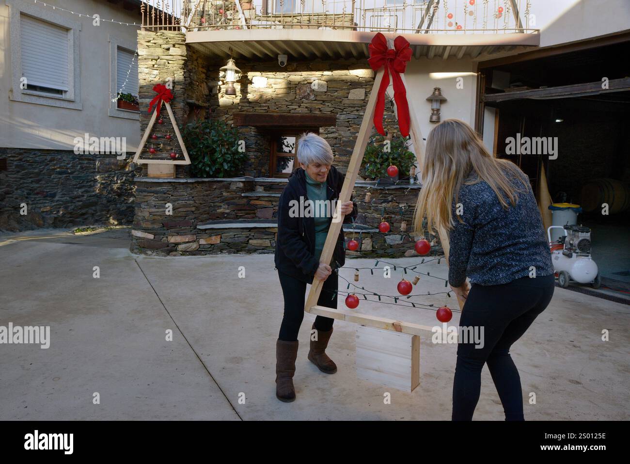 Several neighbors put up Christmas decorations on December 23, 2024, in ...