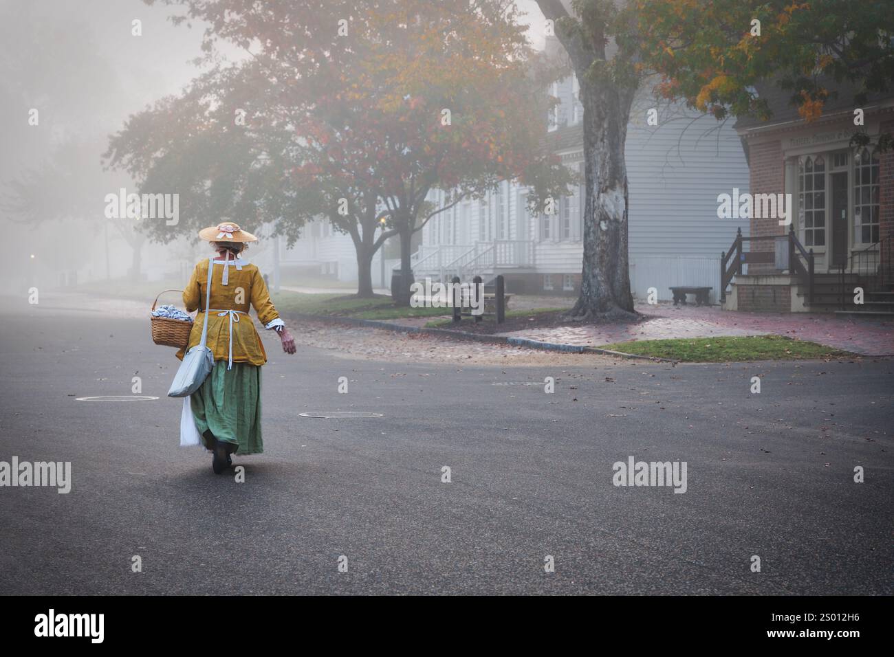 A woman, in period cloting, walks down Duke of Gloucester street on a ...