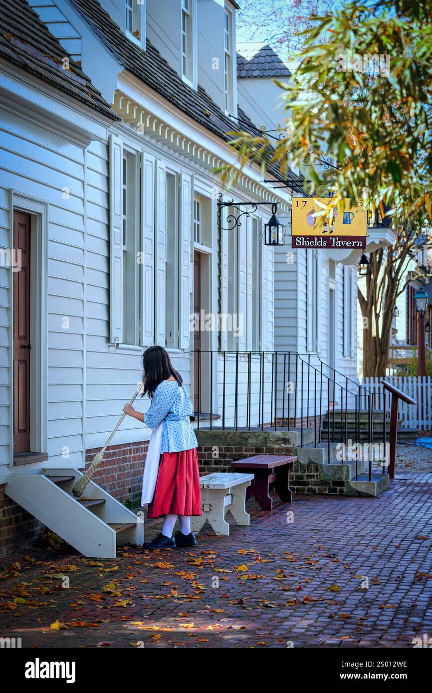 A woman sweeps the stairs outside Shields Tavern in the historic ...
