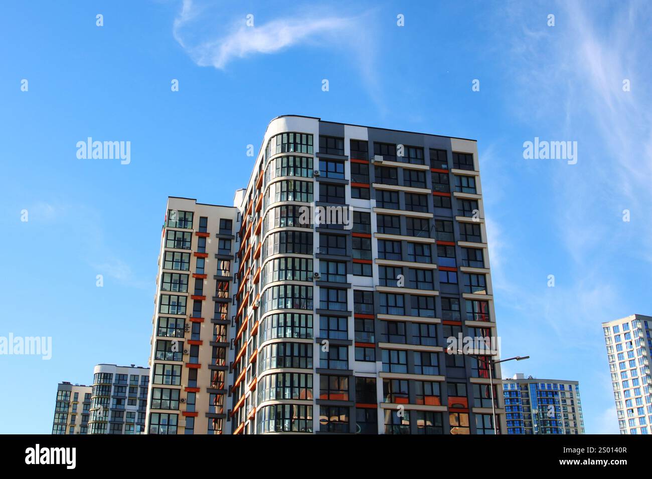 A very tall building reaching high into the sky with a vibrant blue sky ...