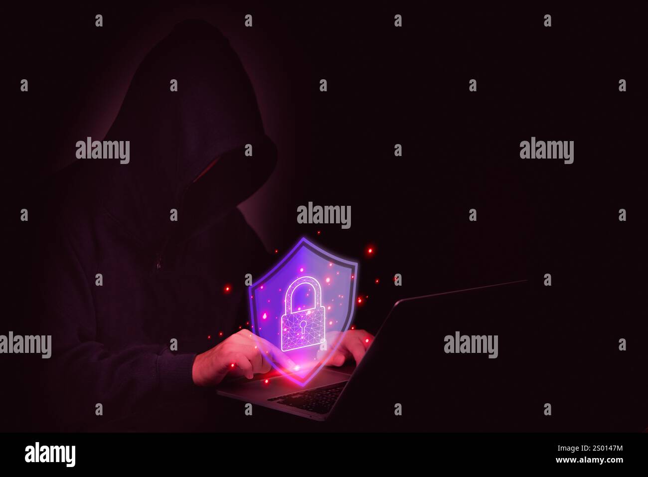 Hooded hacker typing on a laptop with a digital lock shield ...