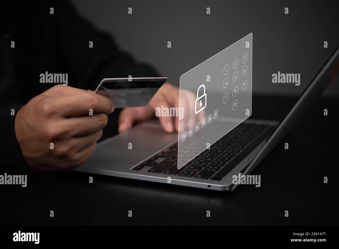 Hand holding credit card near laptop screen with a security lock icon ...