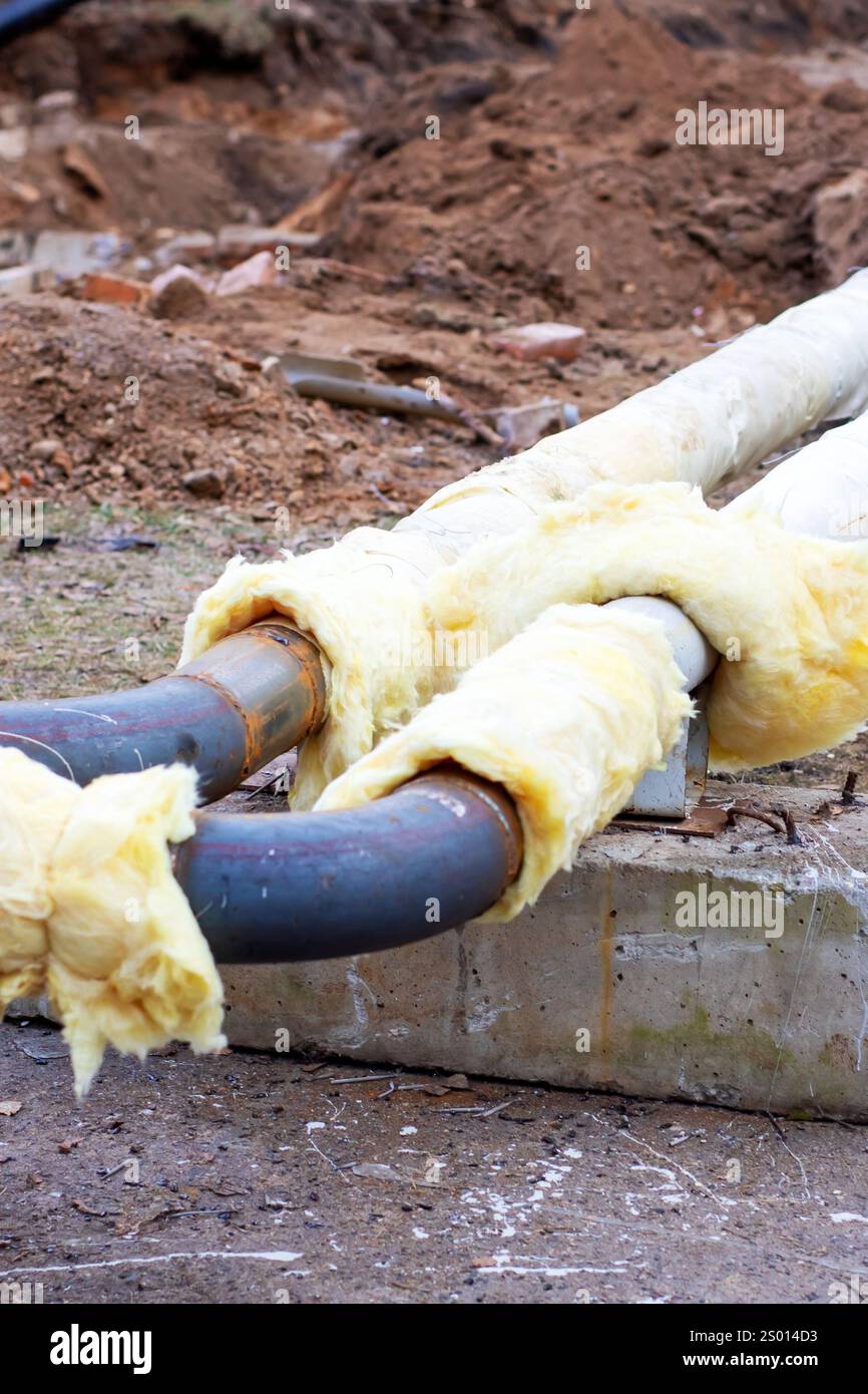 A pair of pipes that are thoroughly covered in protective insulation ...