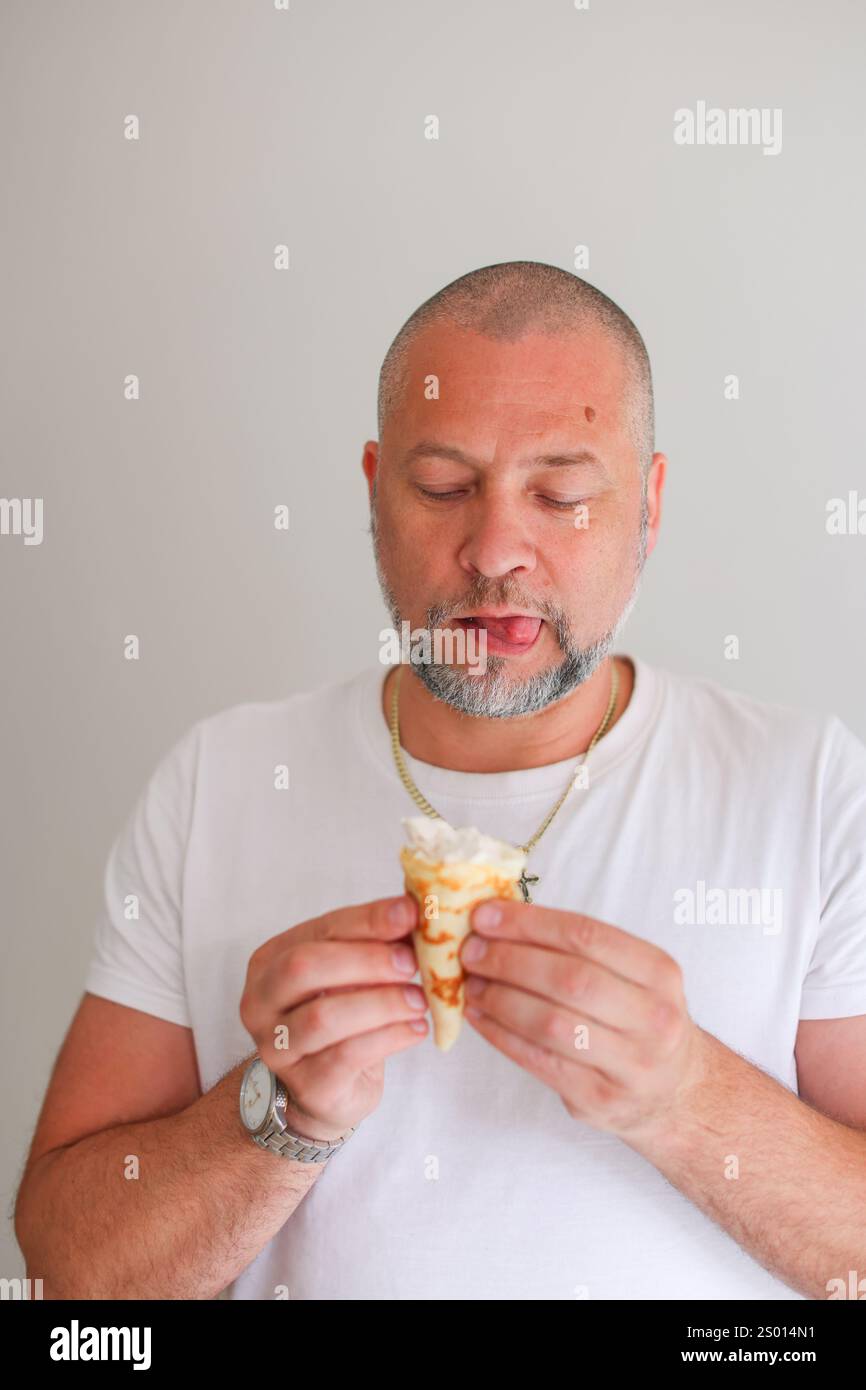 man show like and eat pancakes with cream. Positive man eating healthy ...