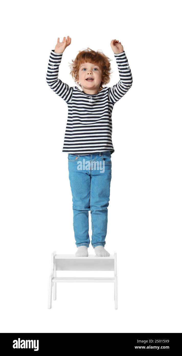 Little boy standing on step stool against white background Stock Photo ...