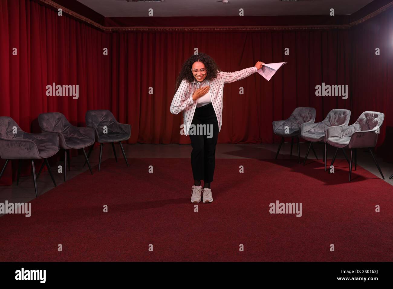 Professional actress bowing on stage in theatre Stock Photo - Alamy