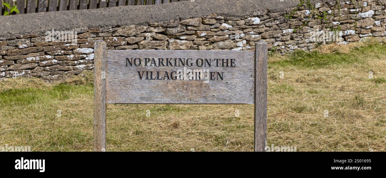 Rustic No Parking on Village Green sign Stock Photo - Alamy