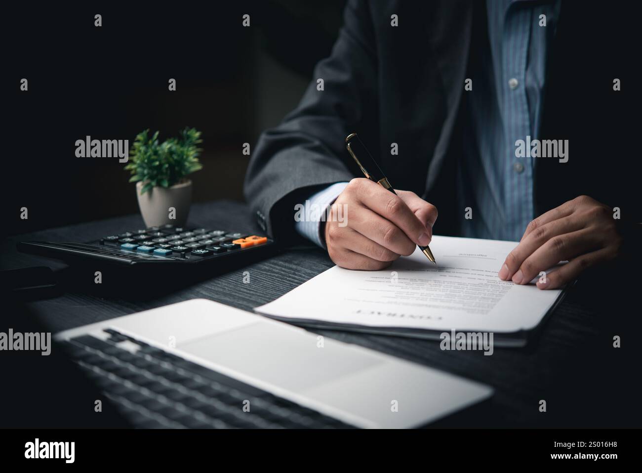 A man is holding a pen, writing or checking a report, working document ...