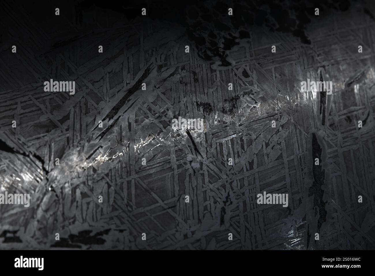 Polished dark meteorite surface with chaotic crysal pattern, abstract ...