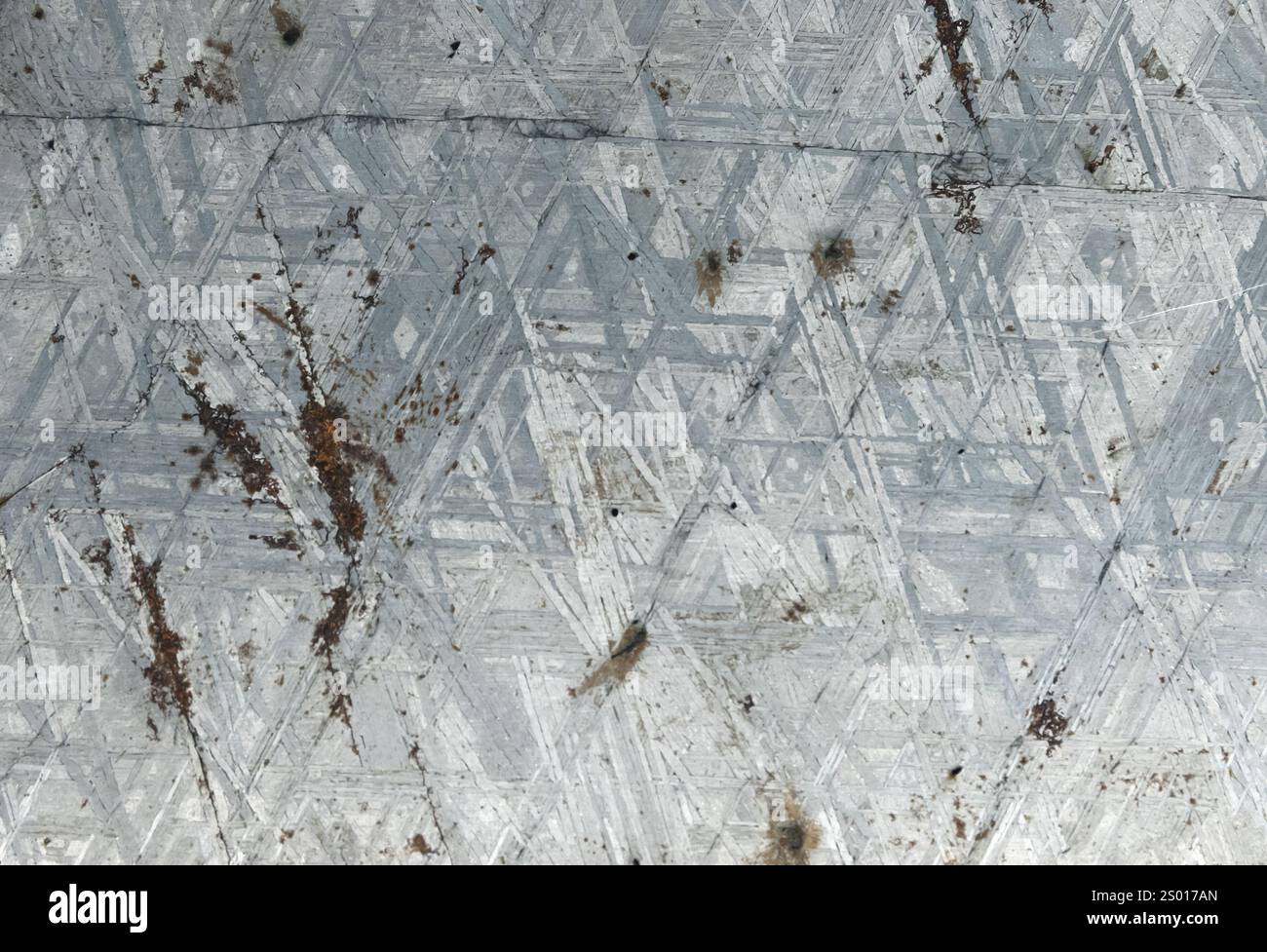 Polished metallic meteorite surface with corrosion over crysal mesh ...