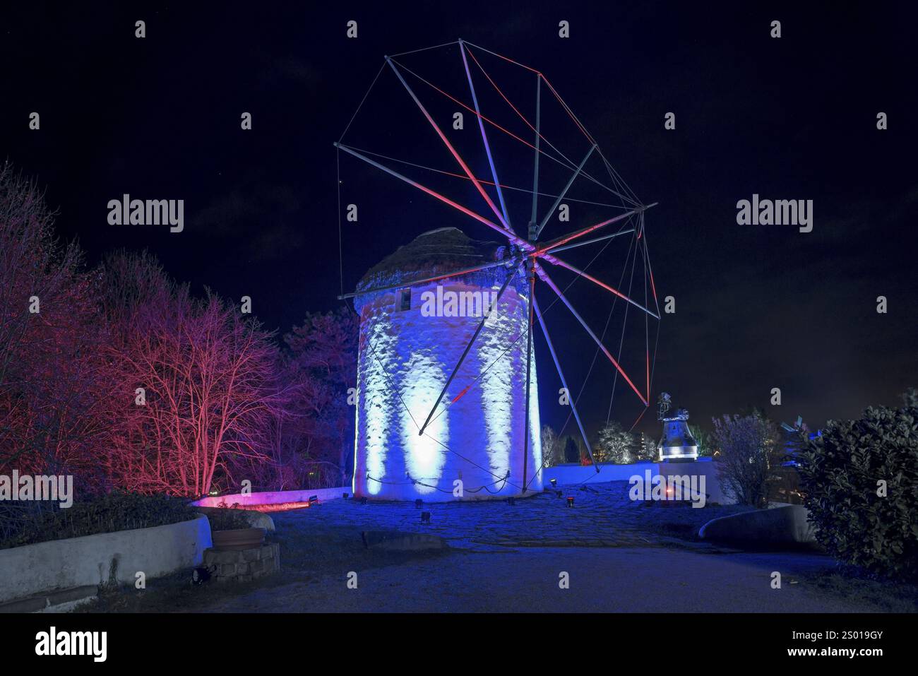 Windmill structure at night with red-blue lighting and surrounding ...