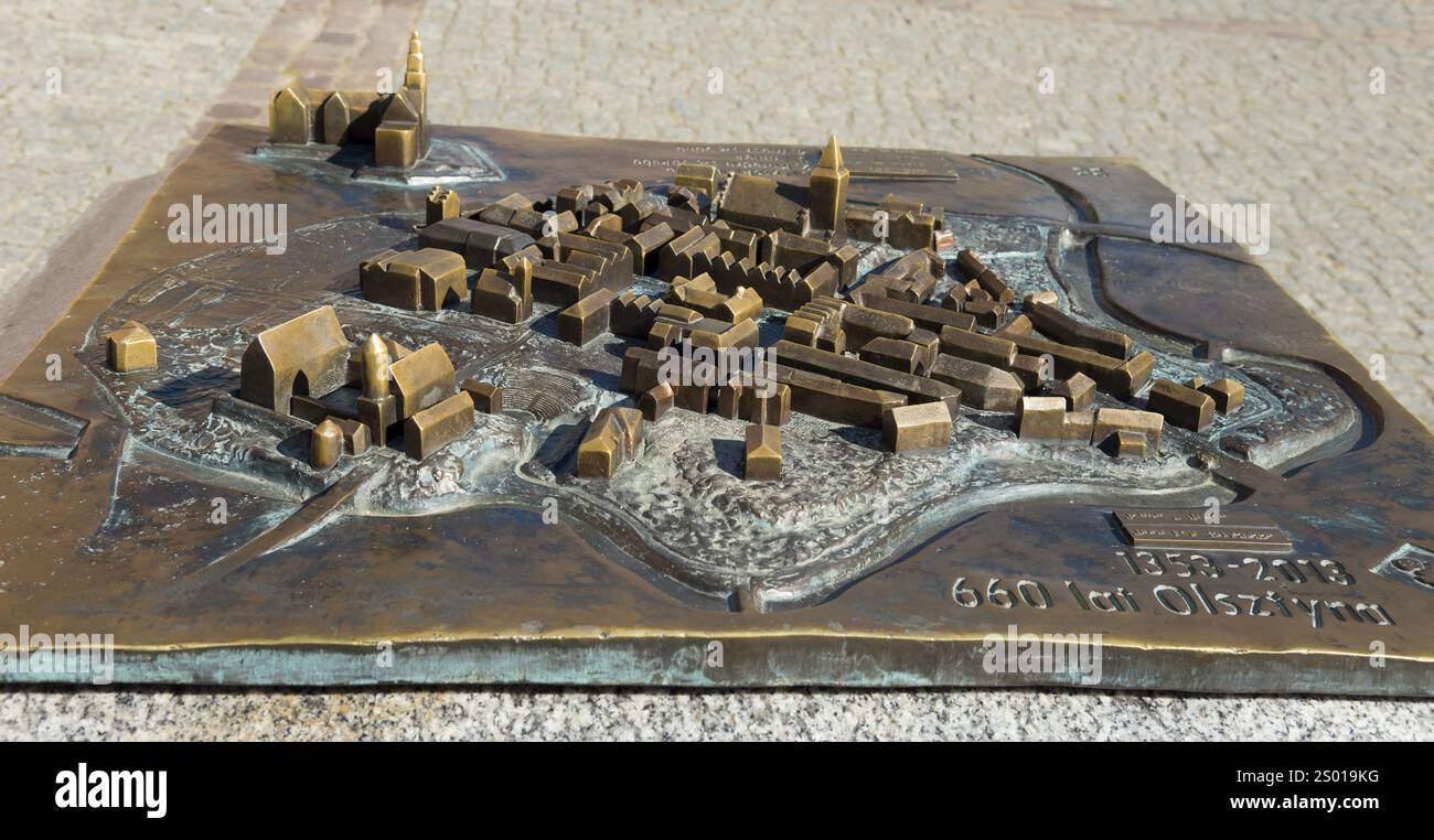 Bronze model of a city with detailed buildings on a stone background ...
