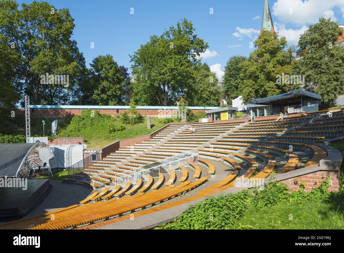 Open-air amphitheatre with rows of seats and surrounding green ...