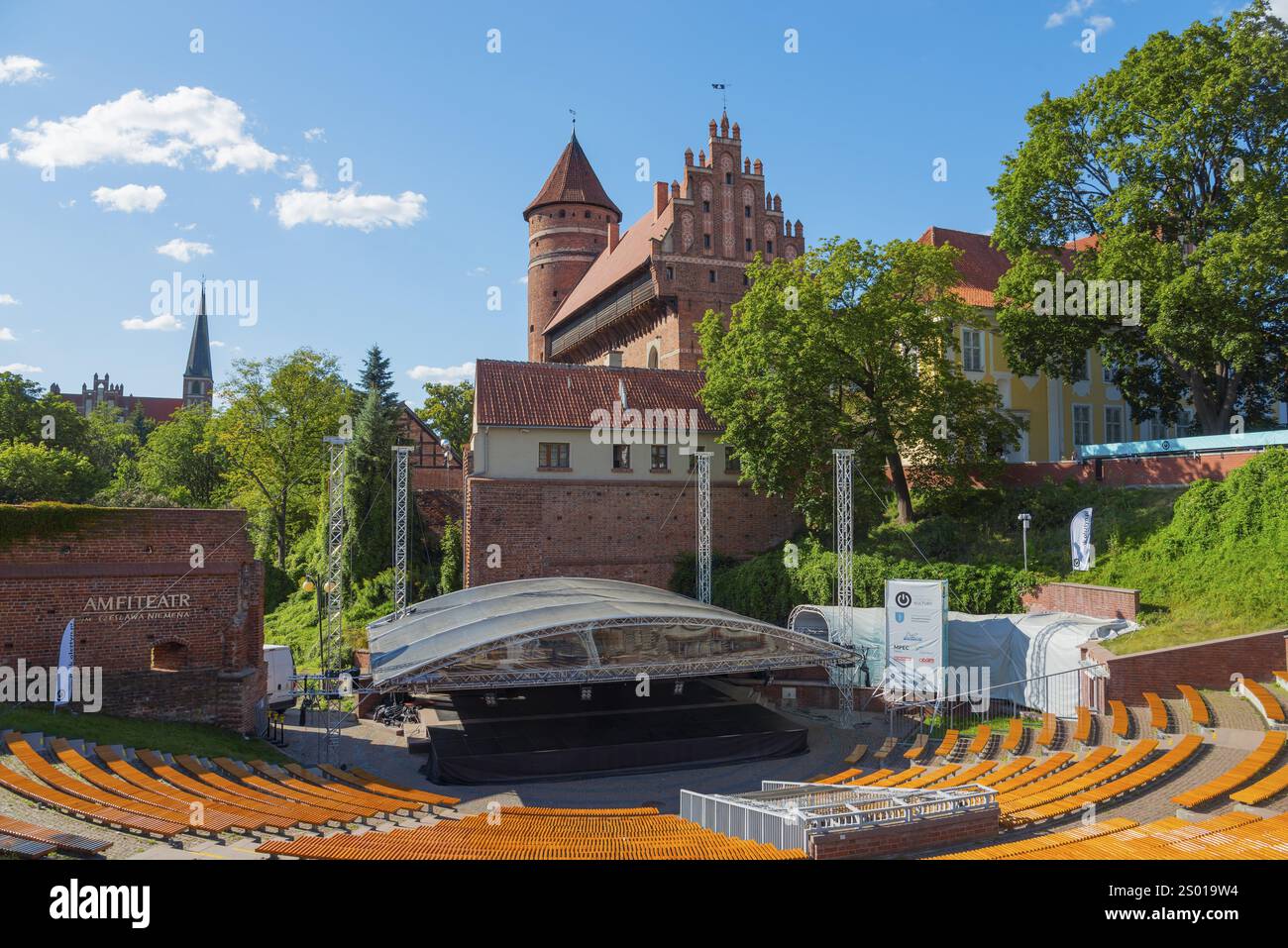 Medieval castle with open-air amphitheatre and surrounding trees ...