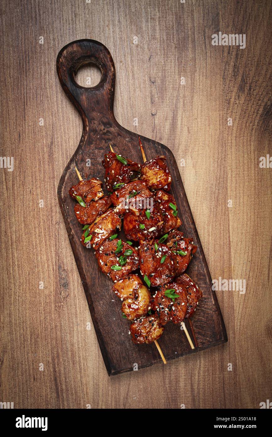 Yakitori chicken kebab, on skewers, with green onions and sesame seeds ...