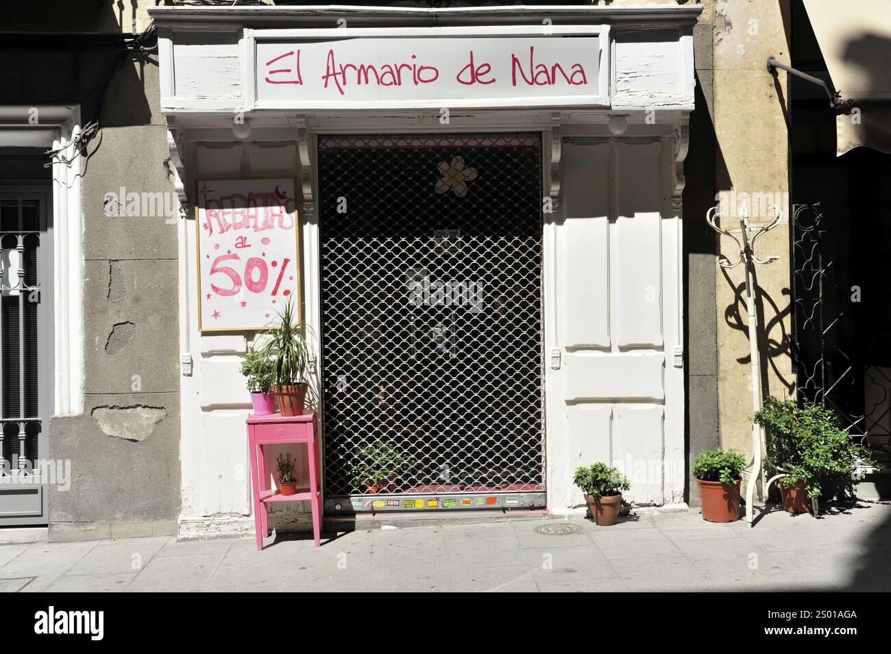 Closed shop front with sign 'El Armario de Nana' and plants, Madrid ...