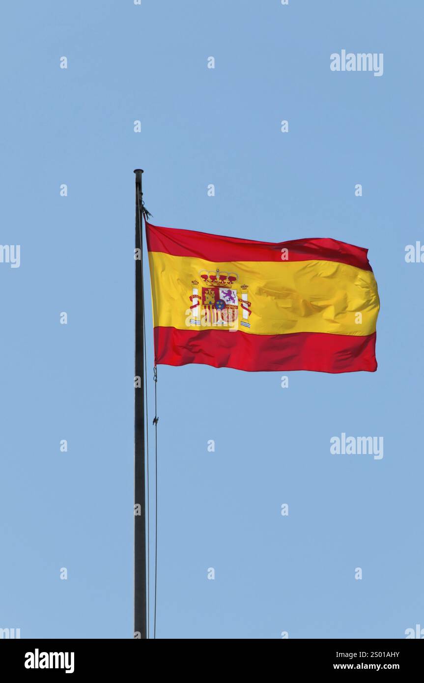 Madrid, Spain, Europe, Spanish flag waving in the wind against a clear ...
