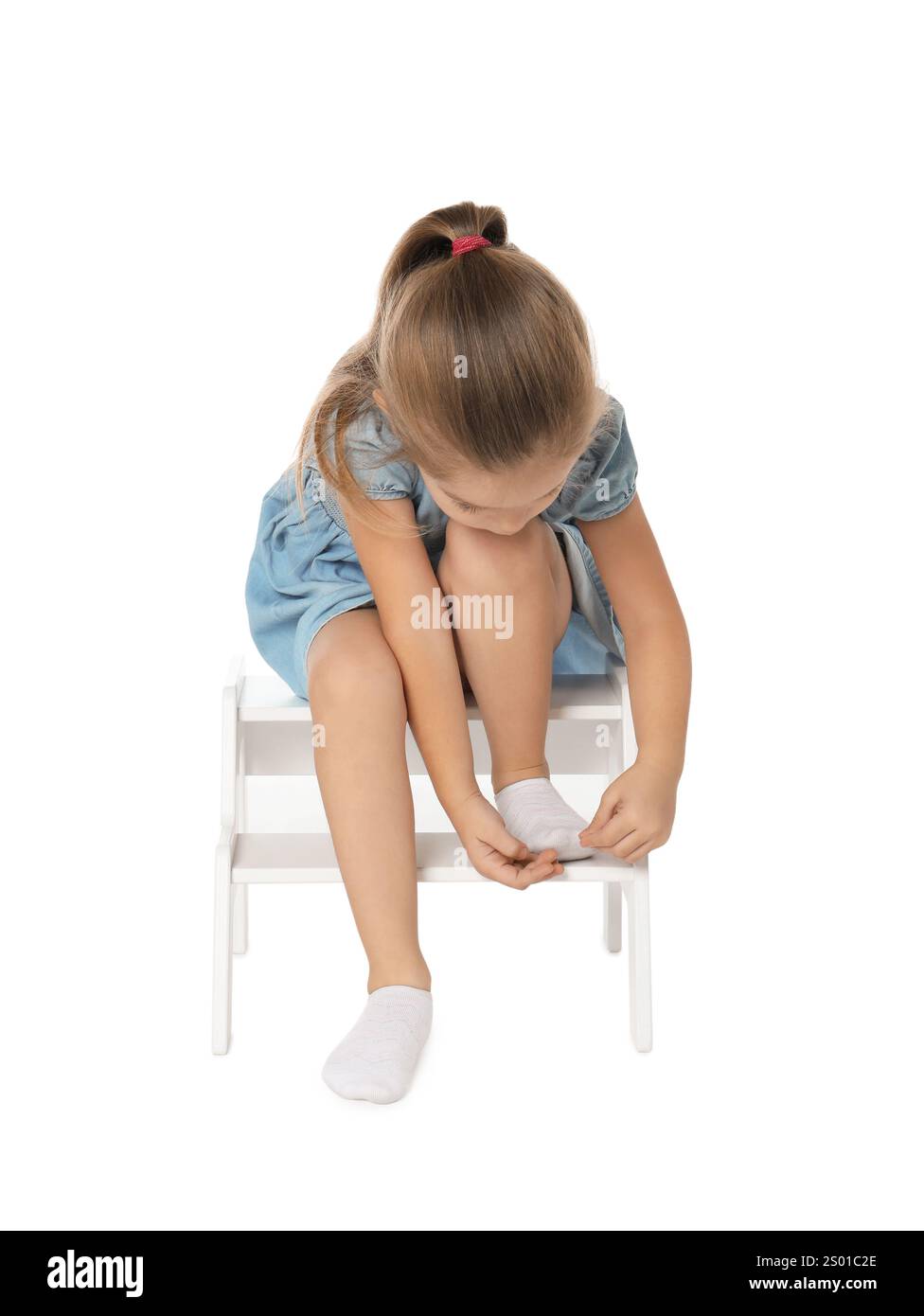 Little girl with step stool on white background Stock Photo - Alamy