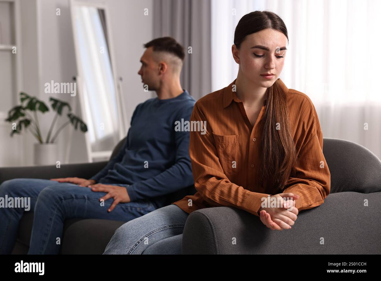Offended couple ignoring each other at home, selective focus Stock ...
