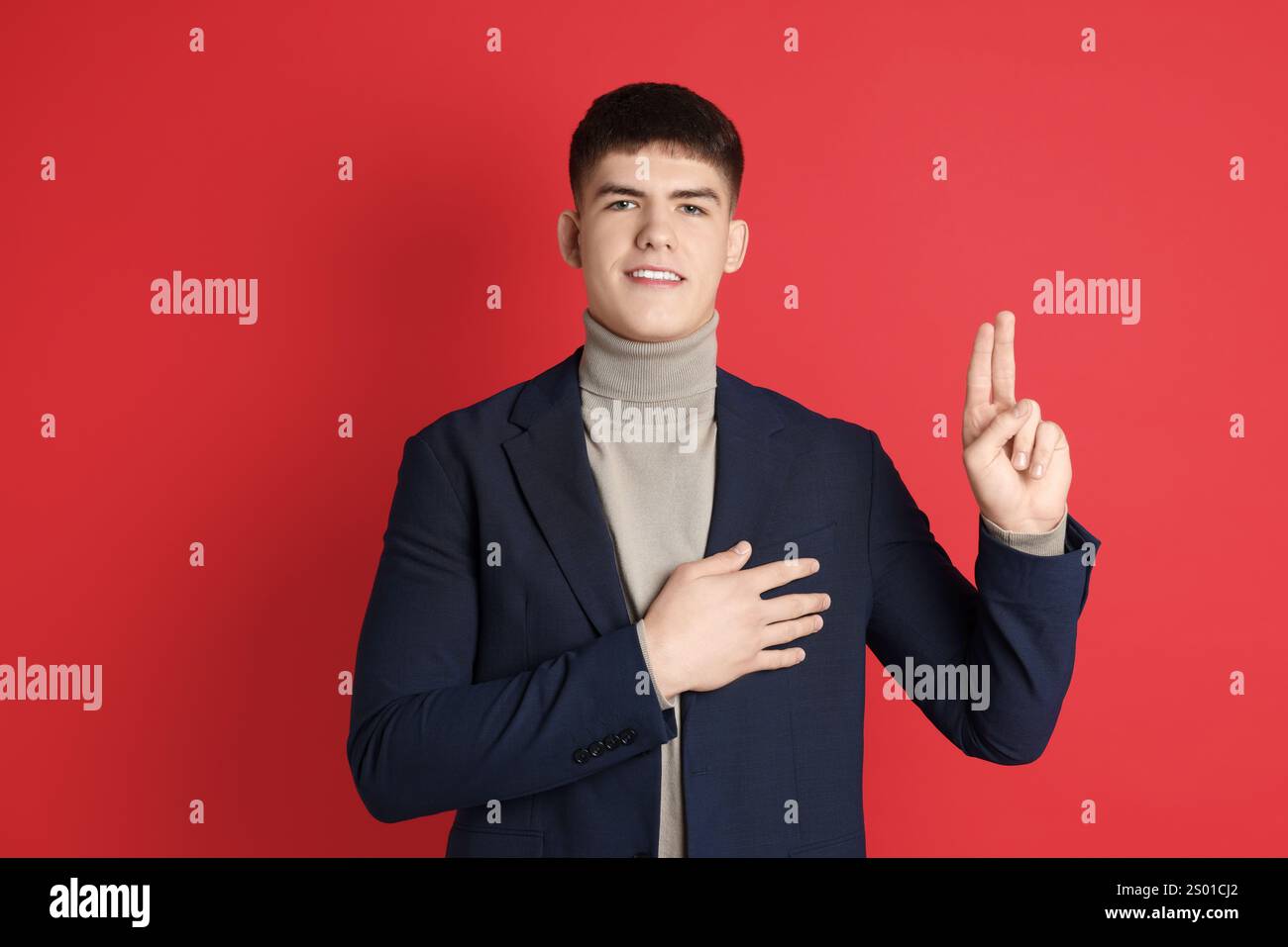 Man showing oath gesture on red background. Making promise Stock Photo ...