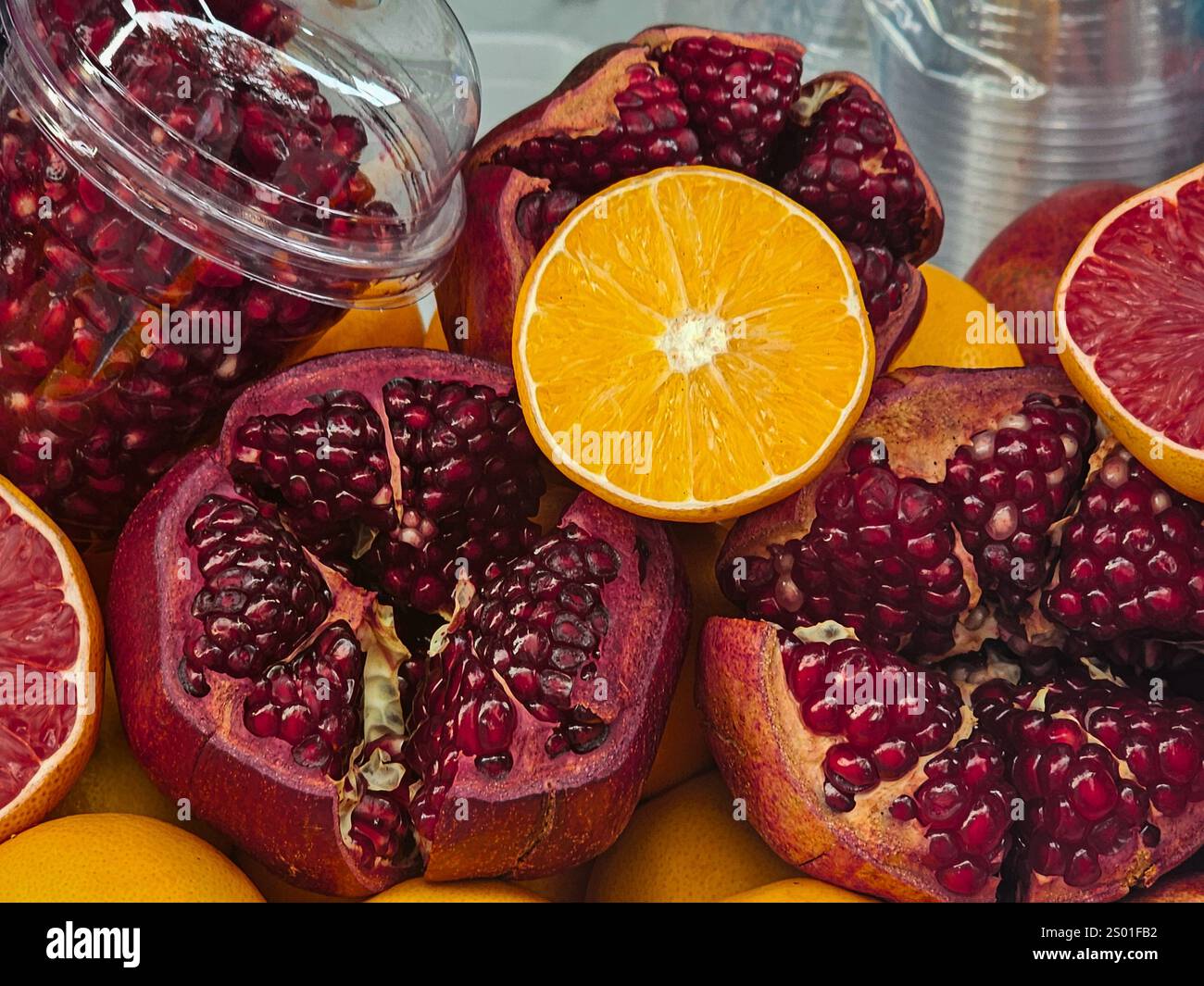 Colorful fruits for sale include pomegranate, pineapple, grapefruits ...
