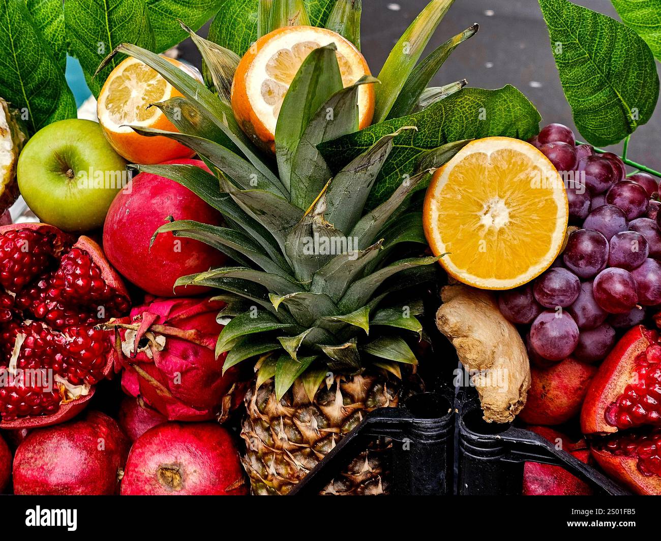 Colorful fruits for sale include pomegranate, pineapple, grapefruits ...