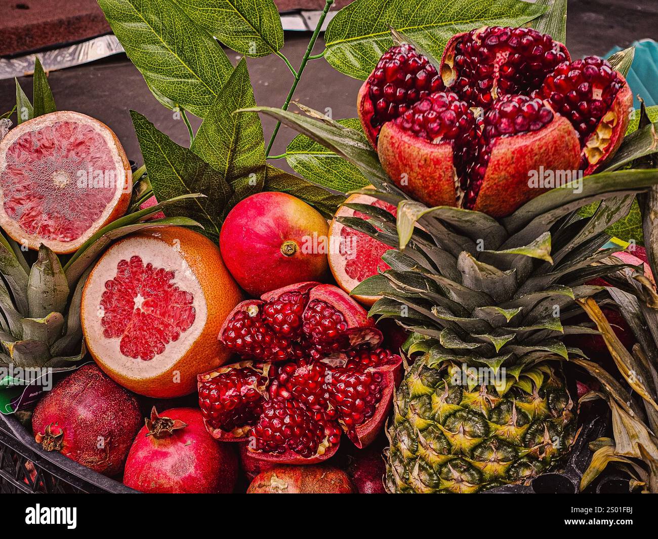 Colorful fruits for sale include pomegranate, pineapple, grapefruits ...