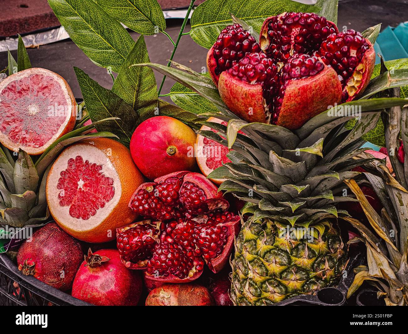 Colorful fruits for sale include pomegranate, pineapple, grapefruits ...