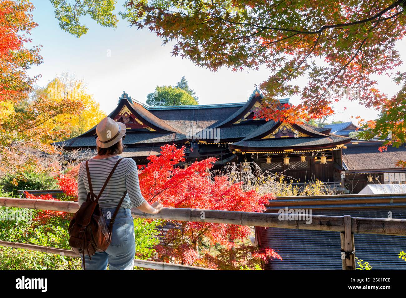 Young woman tourist looking to Kitano Tenmangu, a famous Shinto Shrine ...