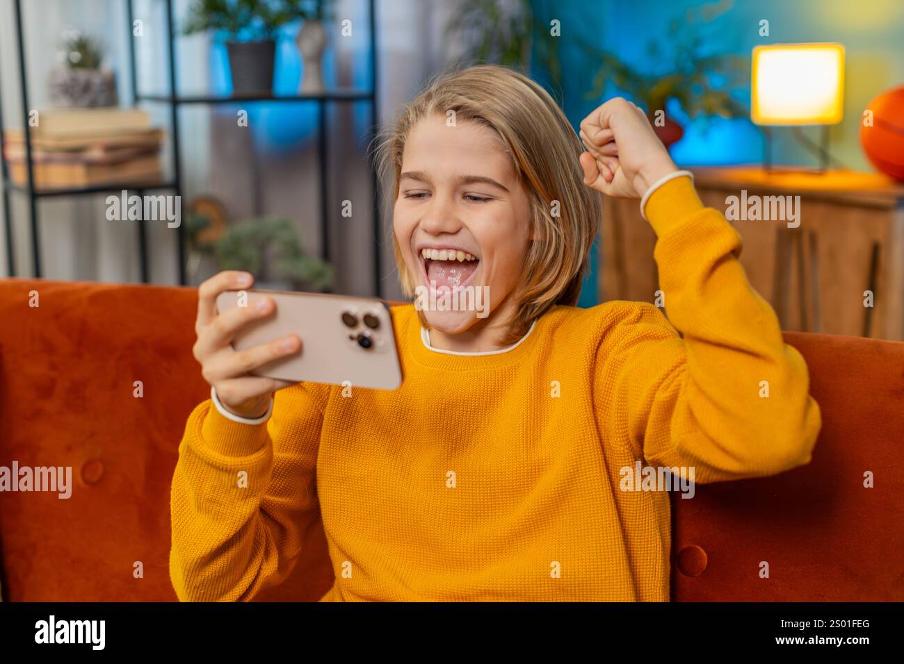 Happy Caucasian teenager boy playing mobile game on smartphone ...