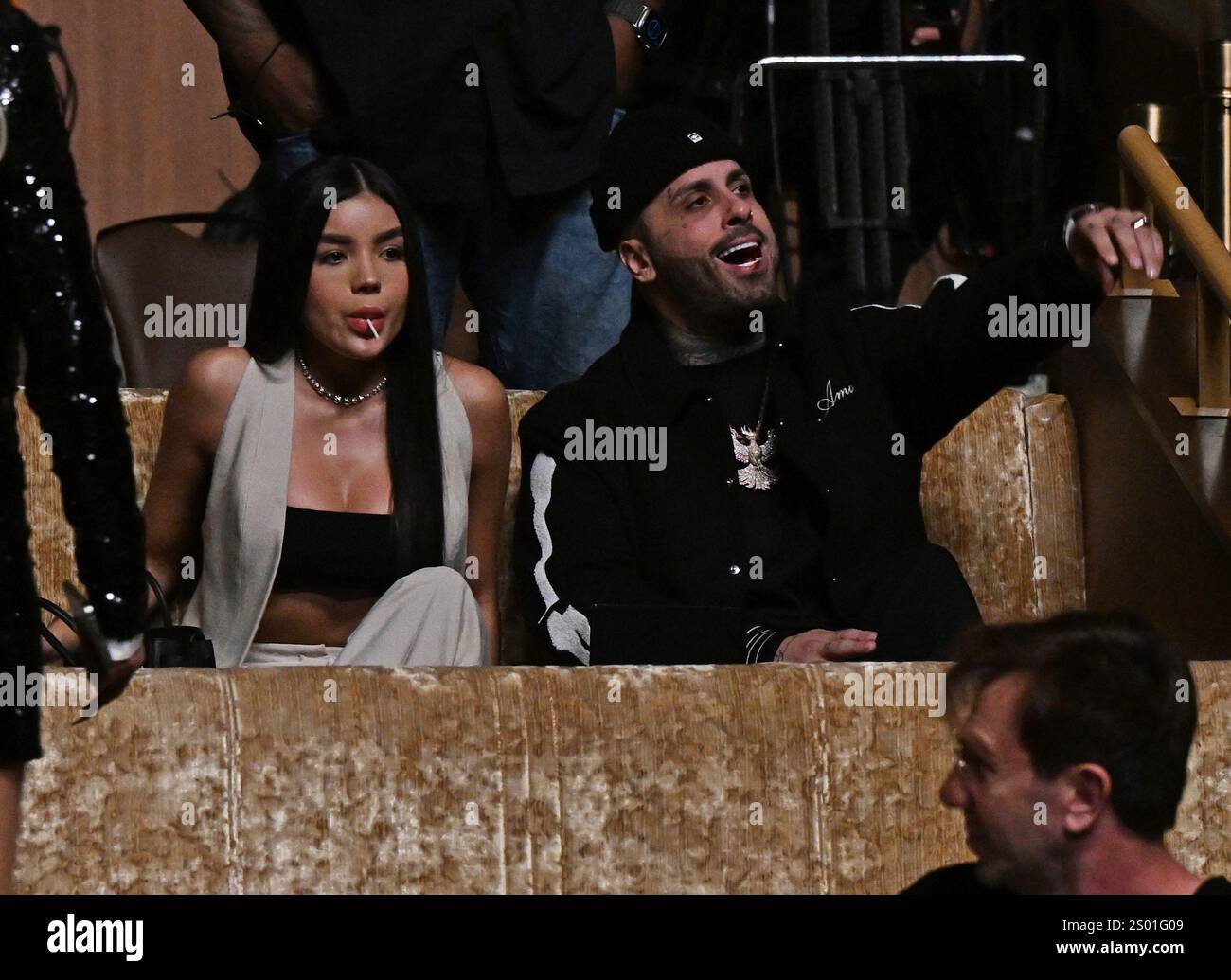 Hollywood FL, USA. 22nd Dec, 2024. Angelica Cruz and Nicky Jam watch as ...