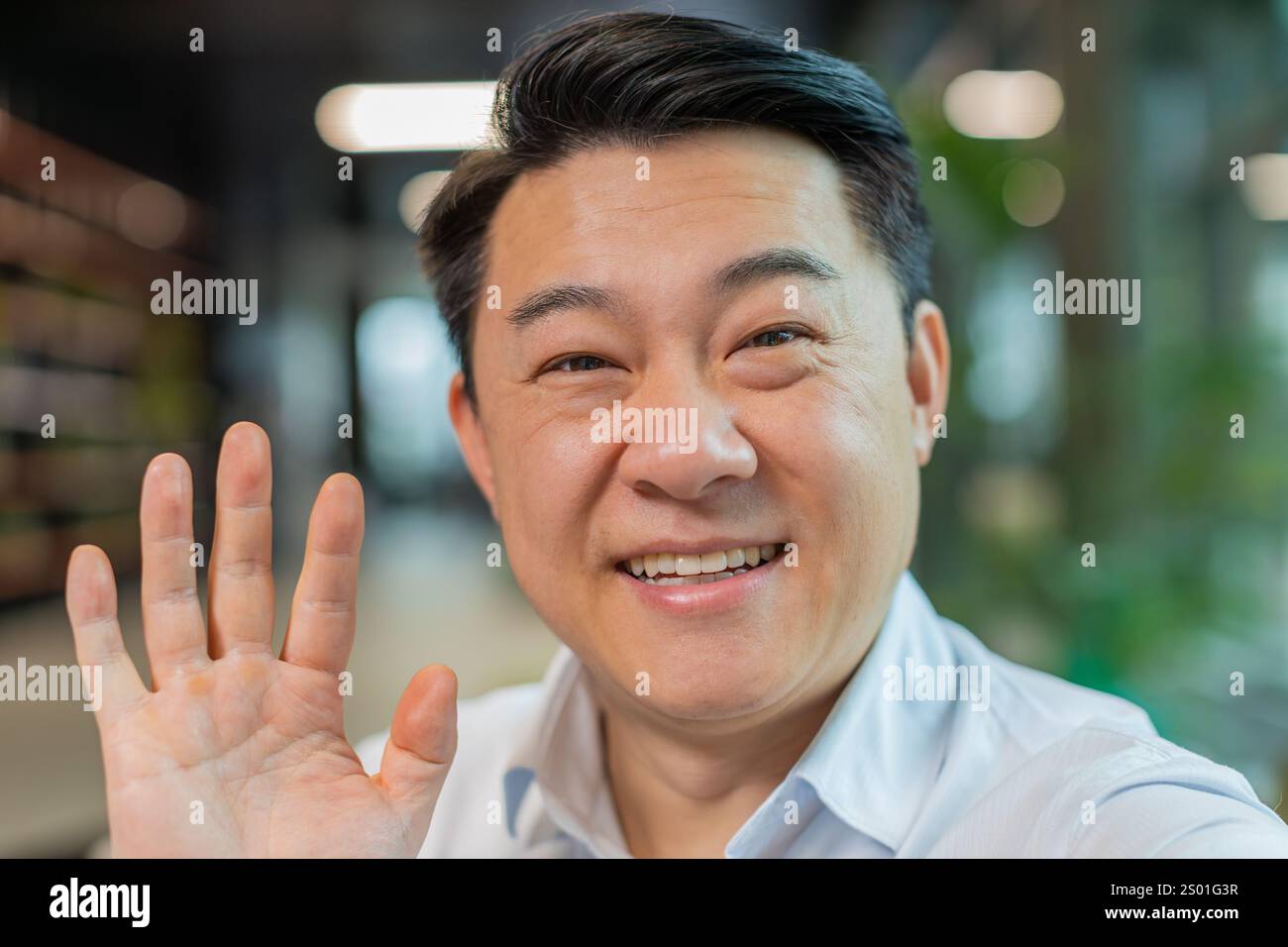 Hello. Closeup portrait of happy Chinese businessman boss waves hand hi ...
