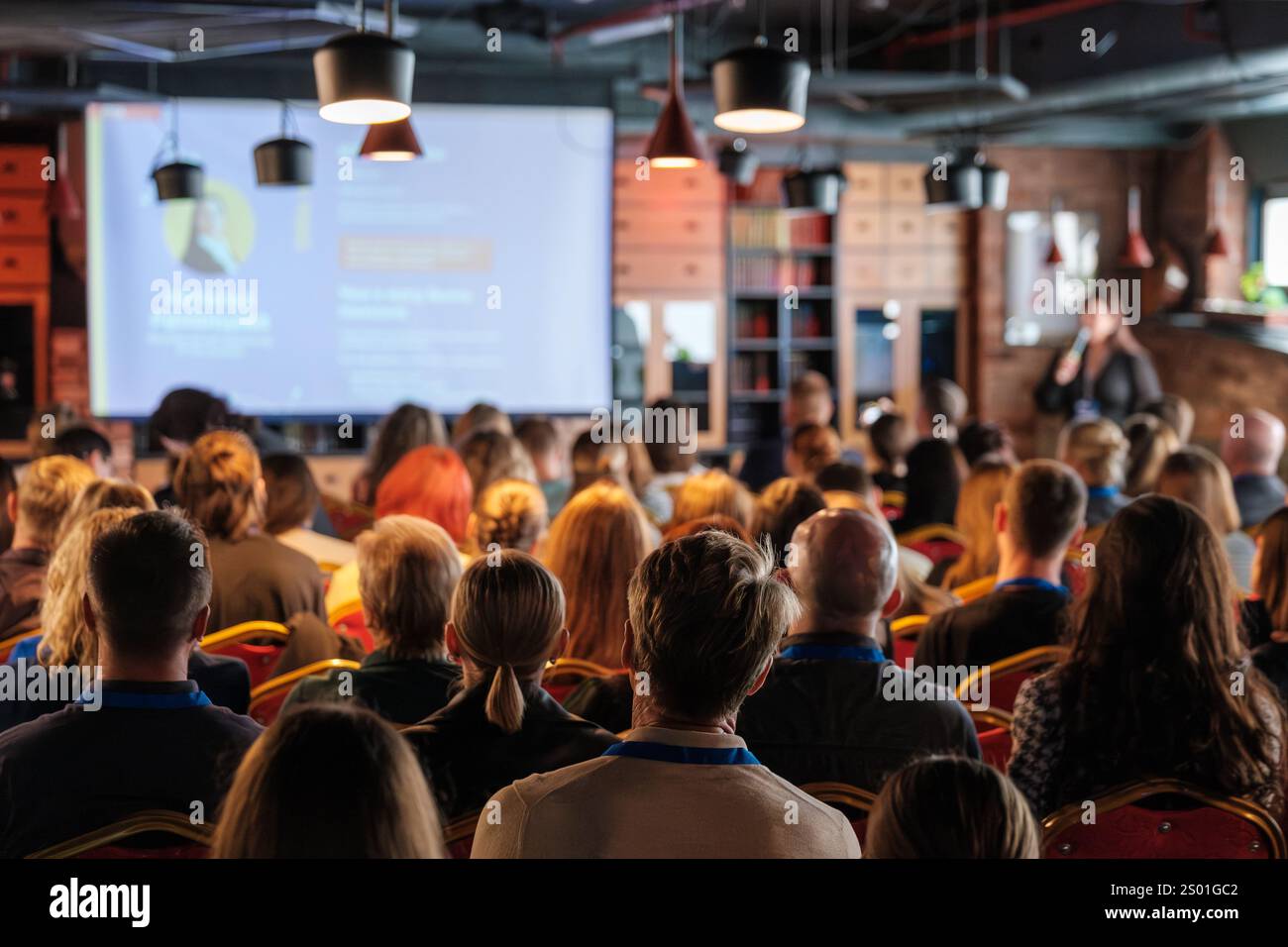 Group of people attending a seminar in a creative indoor space with ...
