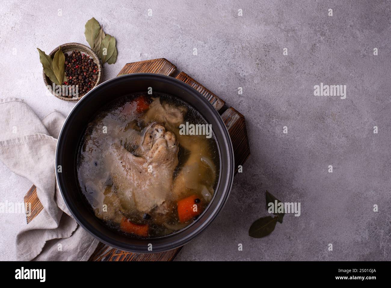 Chicken broth soup or bouillon in pan Stock Photo - Alamy