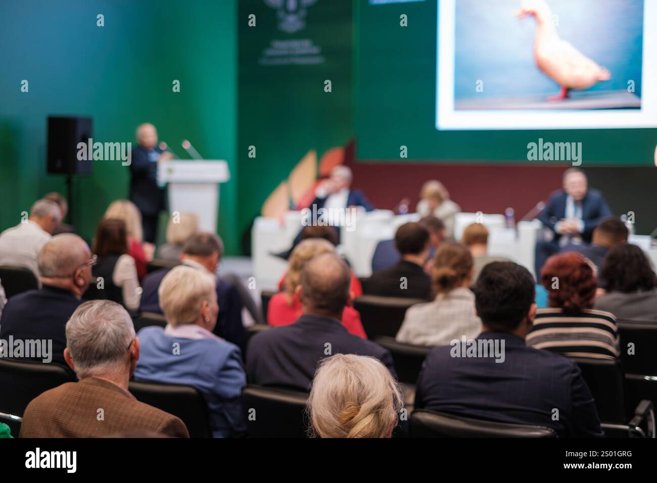Large group of people attending business conference with presentations ...